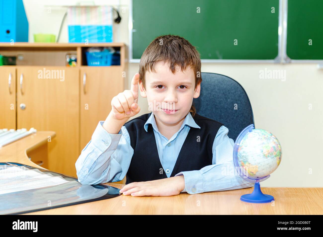 Serious schoolboy in the classroom. Primary school student. Back to ...
