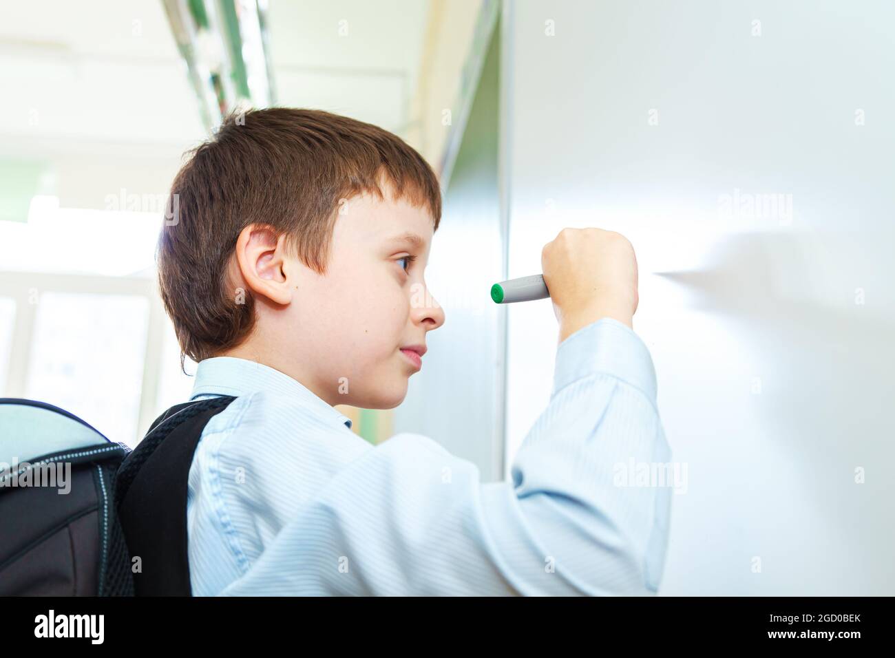 Serious schoolboy in the classroom. Primary school student. Back to ...