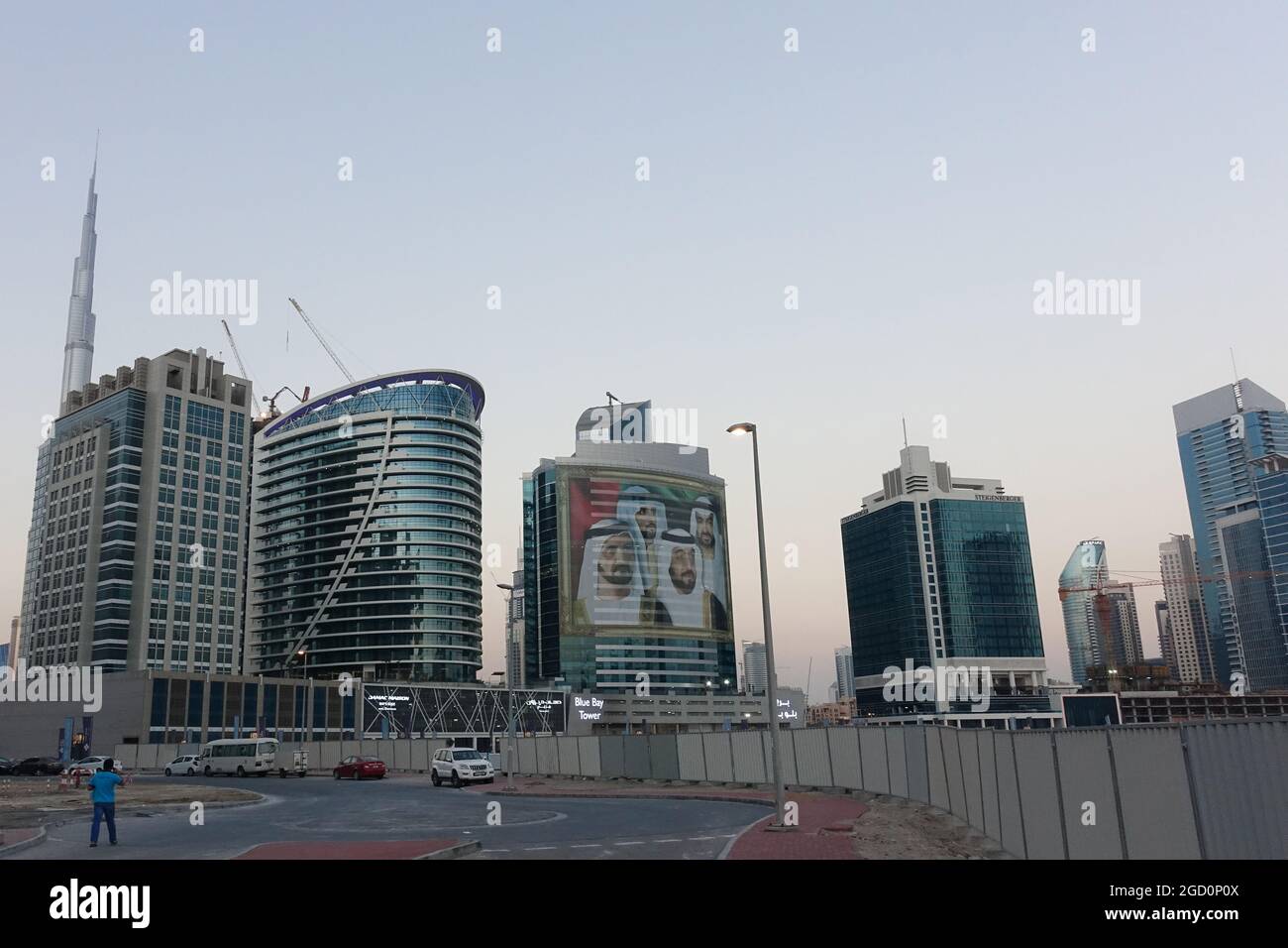 Buildings and Construction behind the Burj Khalifa with poster of Dubai ...