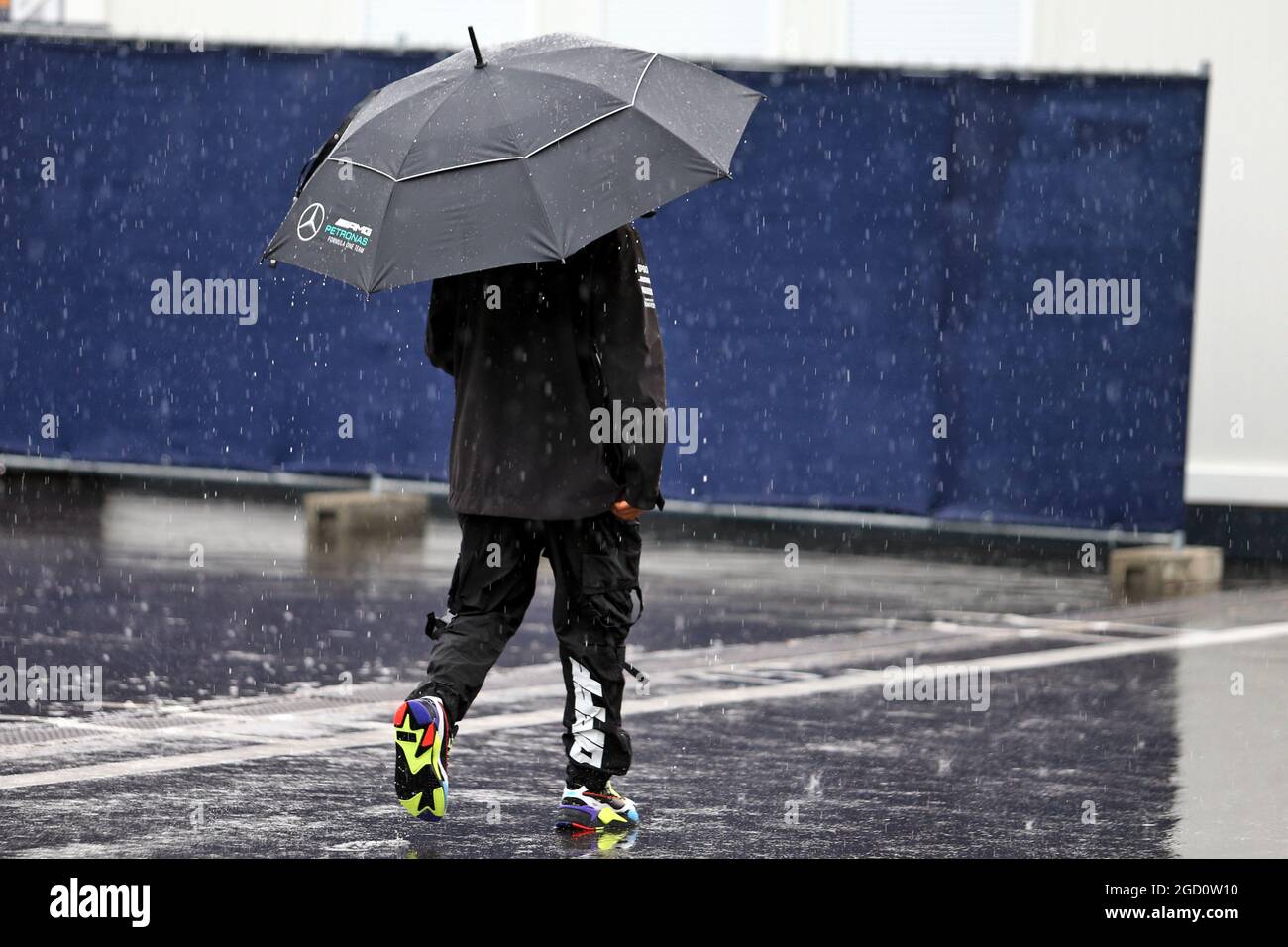 Lewis Hamilton (GBR) Mercedes AMG F1 - heavy rain in the paddock ...