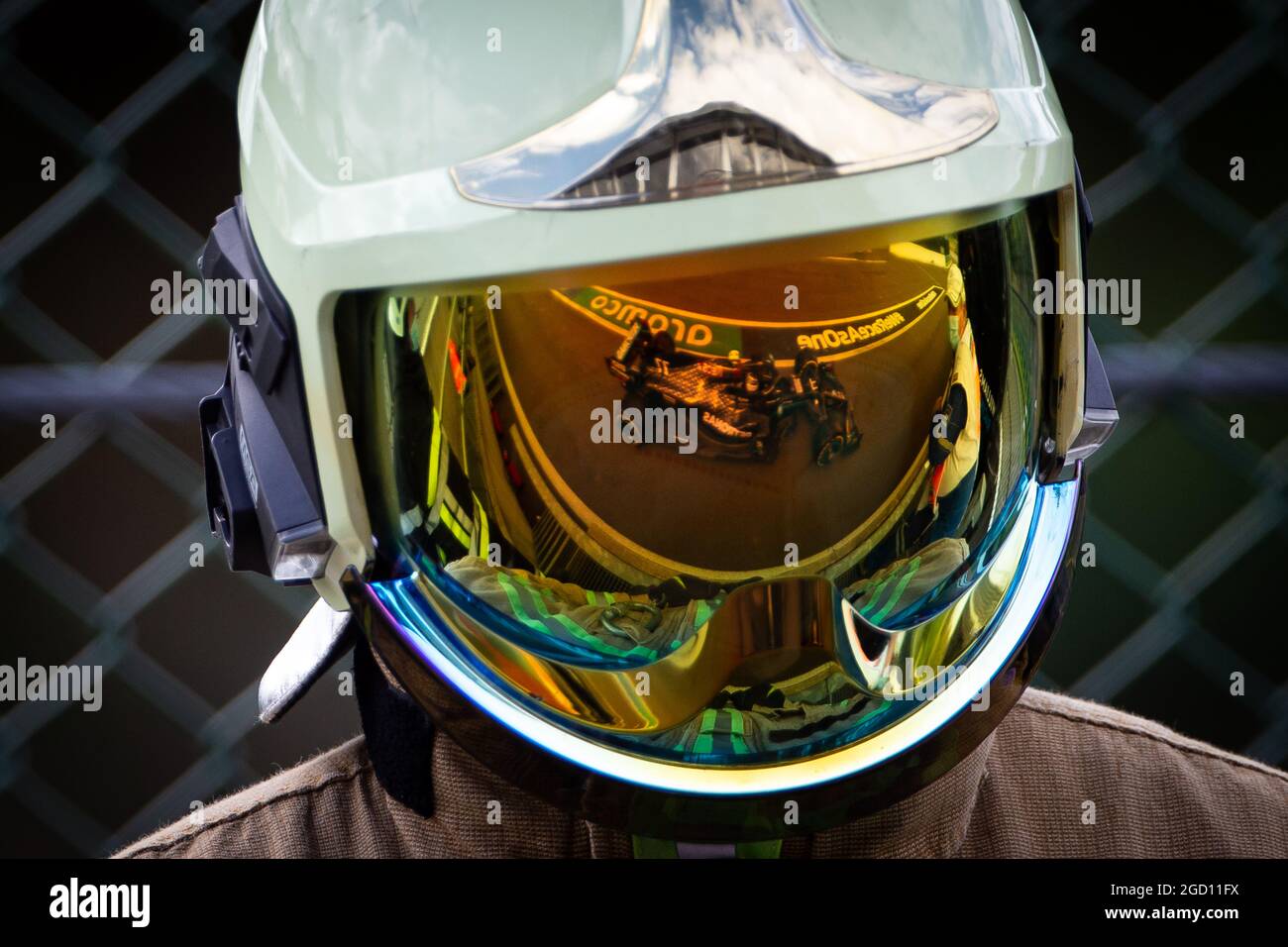 Mercedes amg f1 w11 reflected in a firemans helmet visor hi-res stock ...