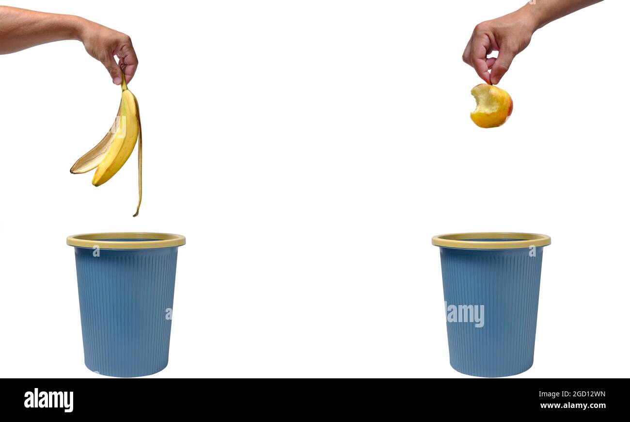 Banana peel and apple core are thrown into the trash, food waste Stock ...
