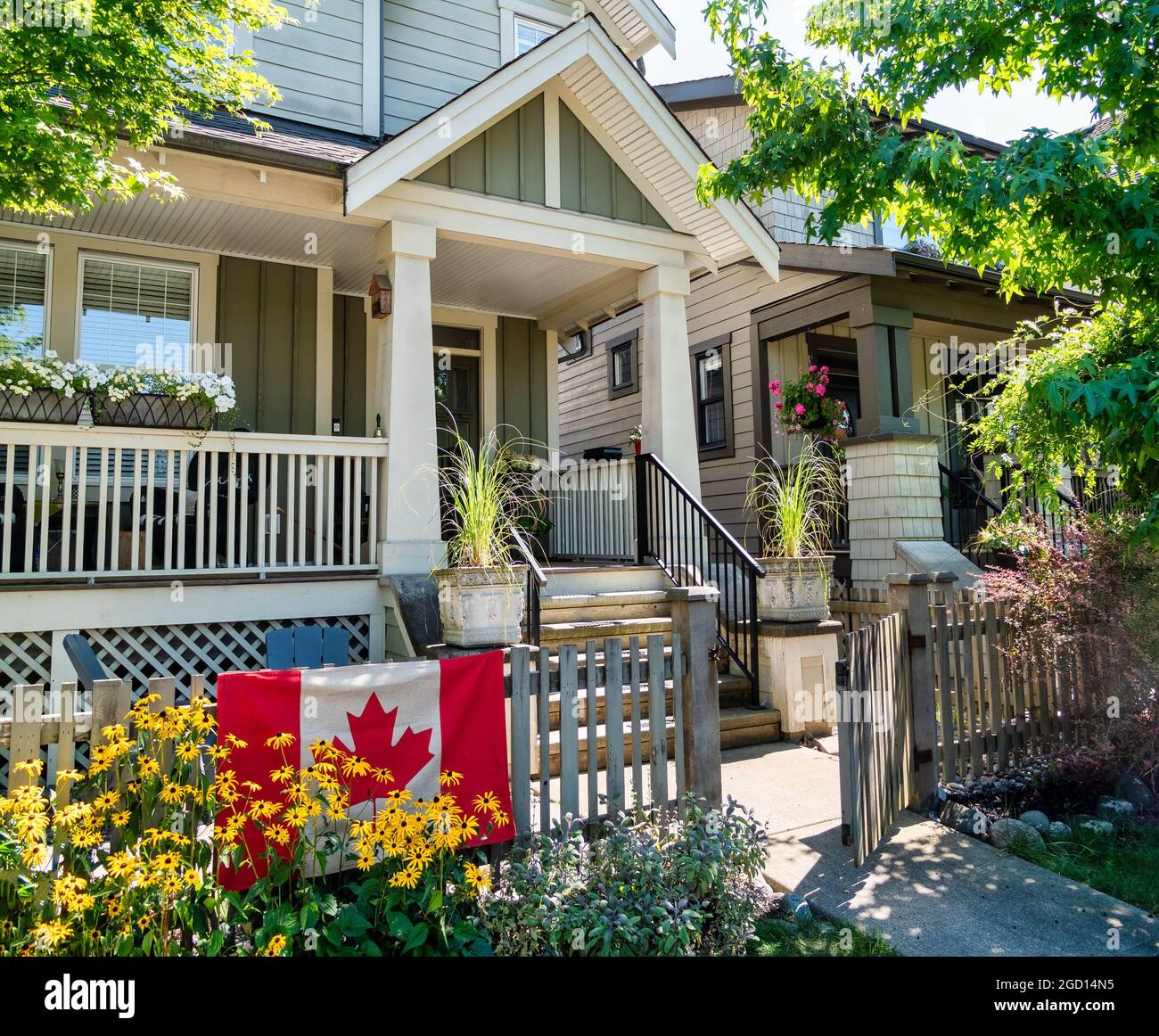 Porch and entrance of residential house with canadian flag on the fence ...