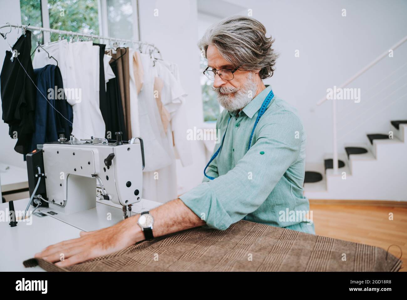 Clothing stylist creating a new design for a dress - Fashion designer ...