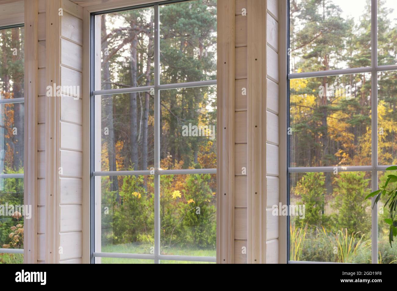 Bright interior of the room in wooden house with a large window ...
