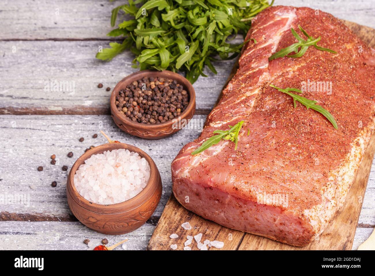 A piece of raw pork loin. Marinated fresh meat with spices. Chili ...