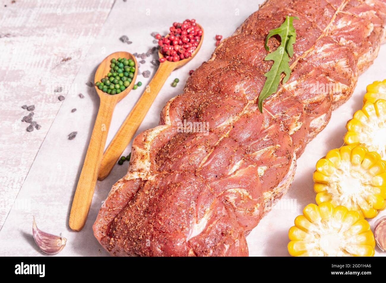 A piece of raw pork loin. Marinated fresh meat tied with culinary twine ...