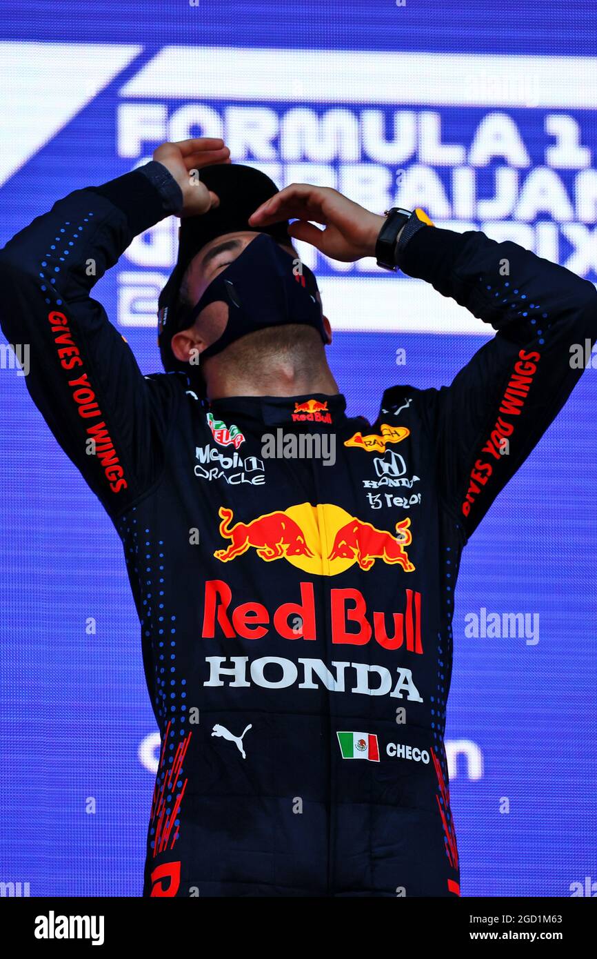 Race winner Sergio Perez (MEX) Red Bull Racing celebrates on the podium ...