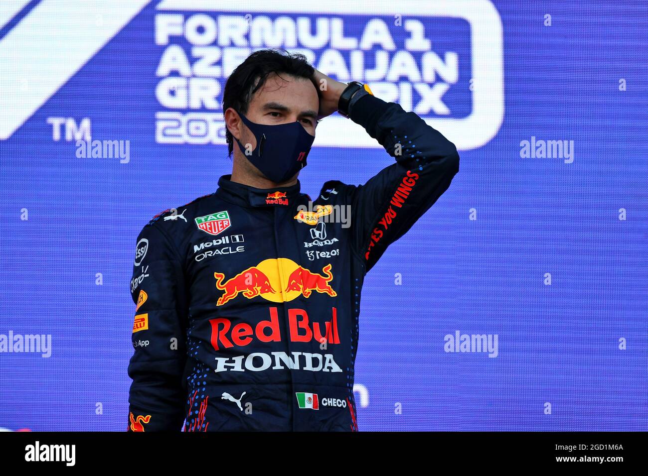 Race winner Sergio Perez (MEX) Red Bull Racing celebrates on the podium ...