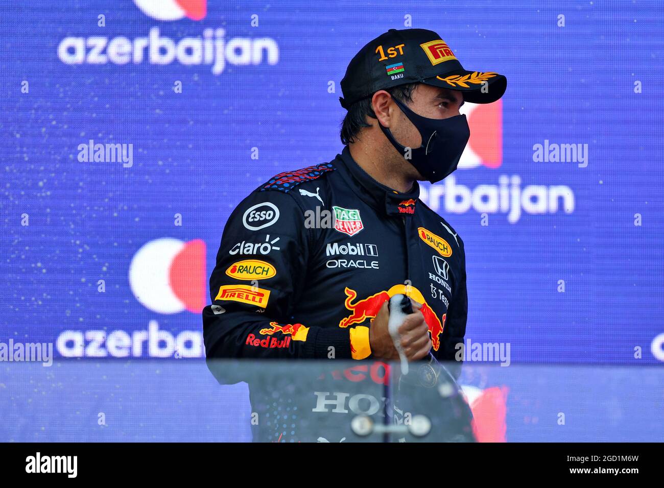 Race winner Sergio Perez (MEX) Red Bull Racing celebrates on the podium ...
