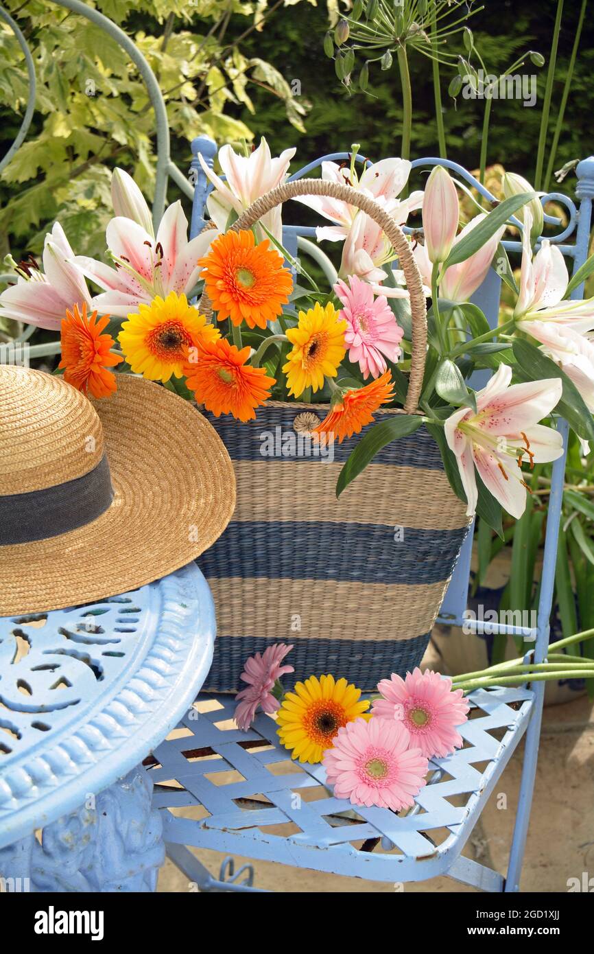 botany, lilium and gerbera in a basket on a chair outdoors, ADDITIONAL ...