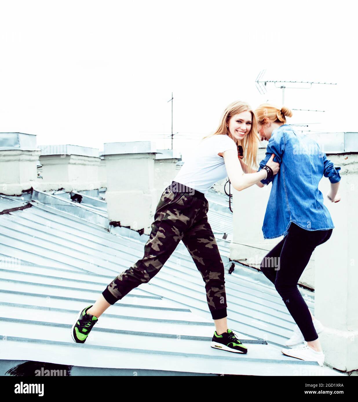 two cool blond real girls friends making selfie on roof top, lifestyle ...