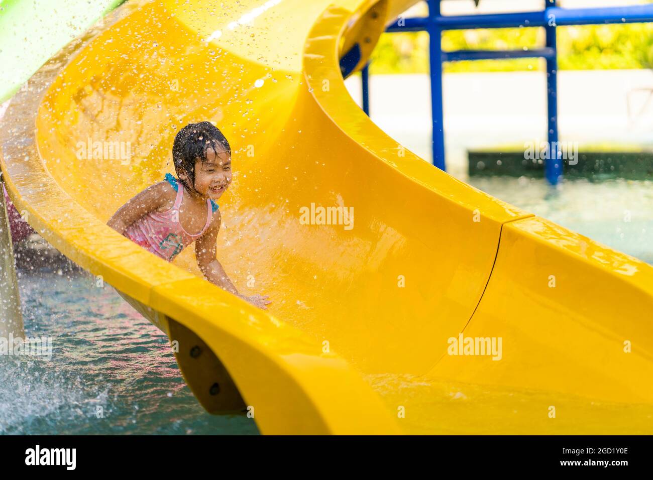 Little girl on water slide hi-res stock photography and images - Alamy