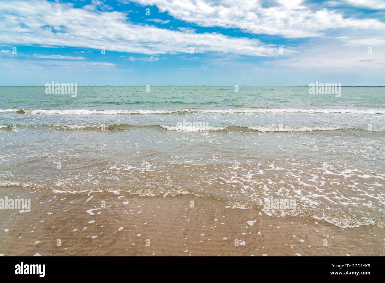 Empty sandy sea beach with small waves Stock Photo - Alamy