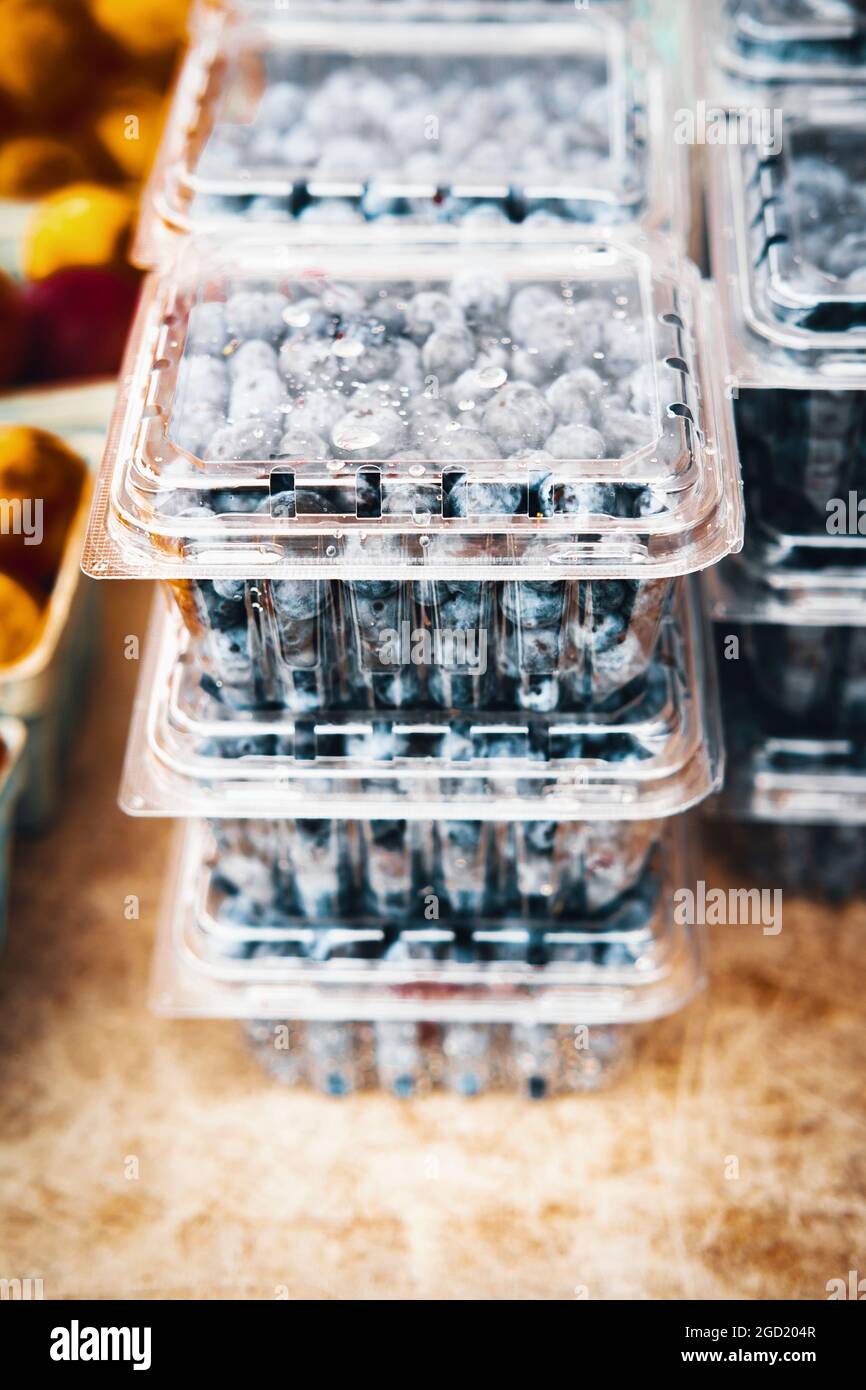 Fresh organic blueberries in plastic containers at local farmers market ...