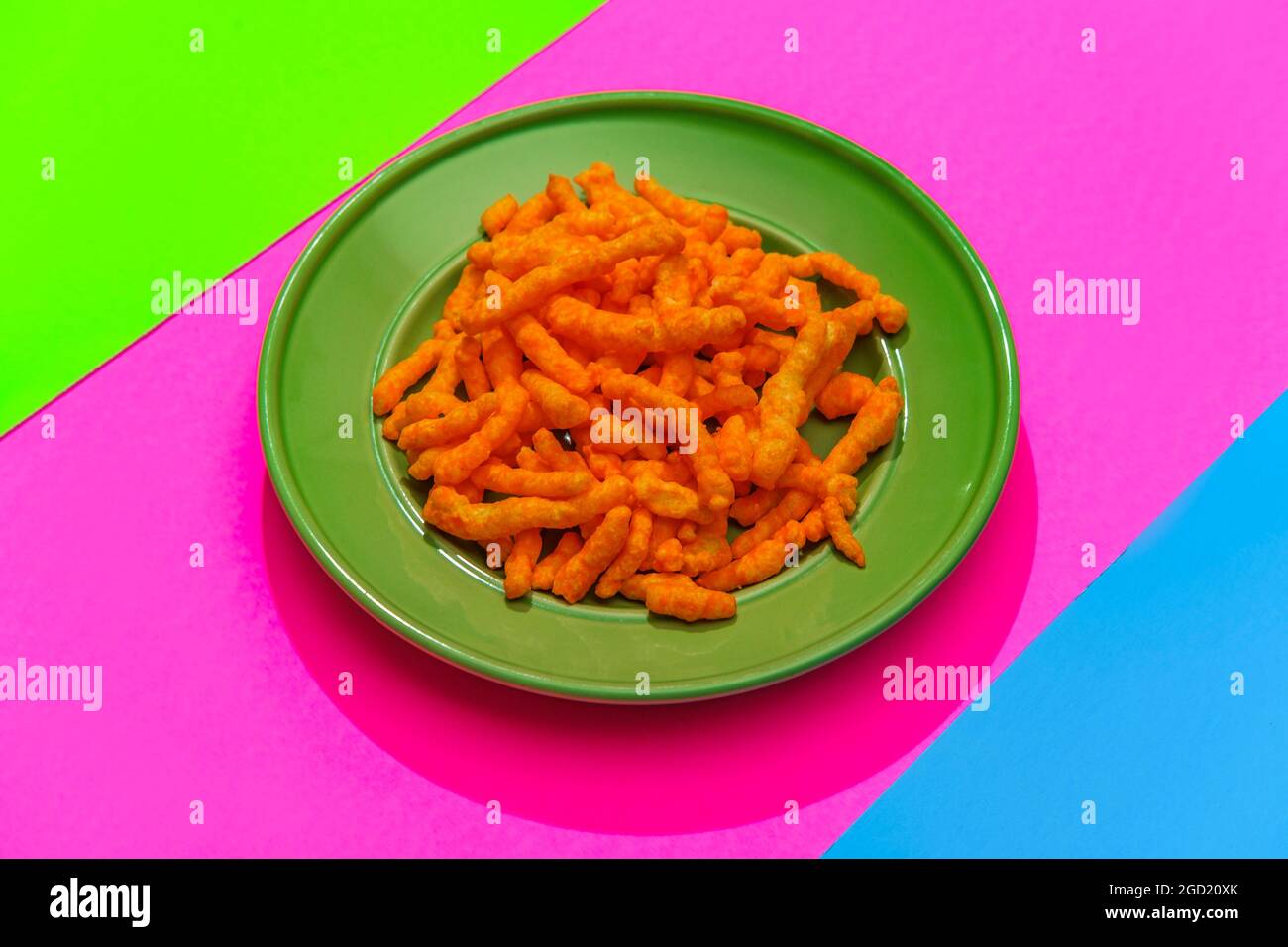 Cheese puff unhealthy junk food snack on stylized modern neon colored ...