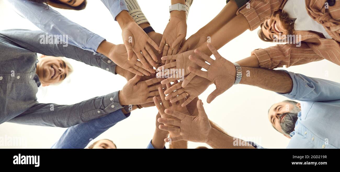 Various of happy men and women folding their arms together as a symbol ...
