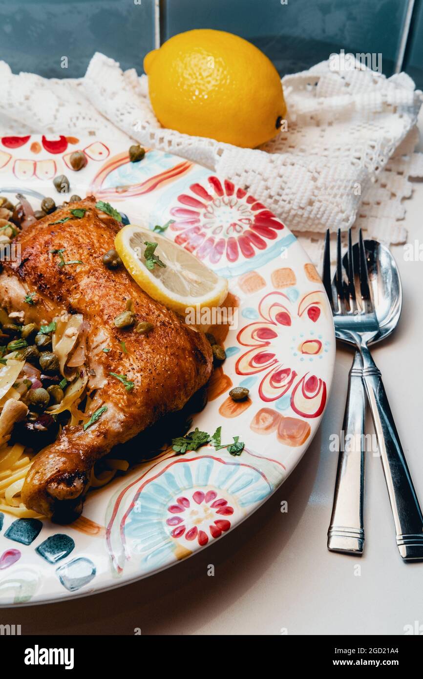 Italian split chicken leg piccata with linguine, artichoke hearts and ...