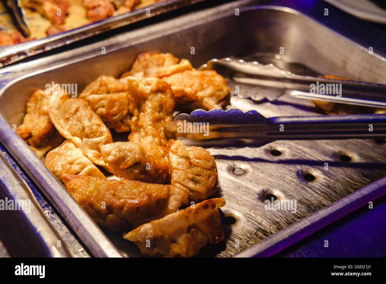 Buffet tray of fried Asian potsticker pork dumplings Stock Photo - Alamy