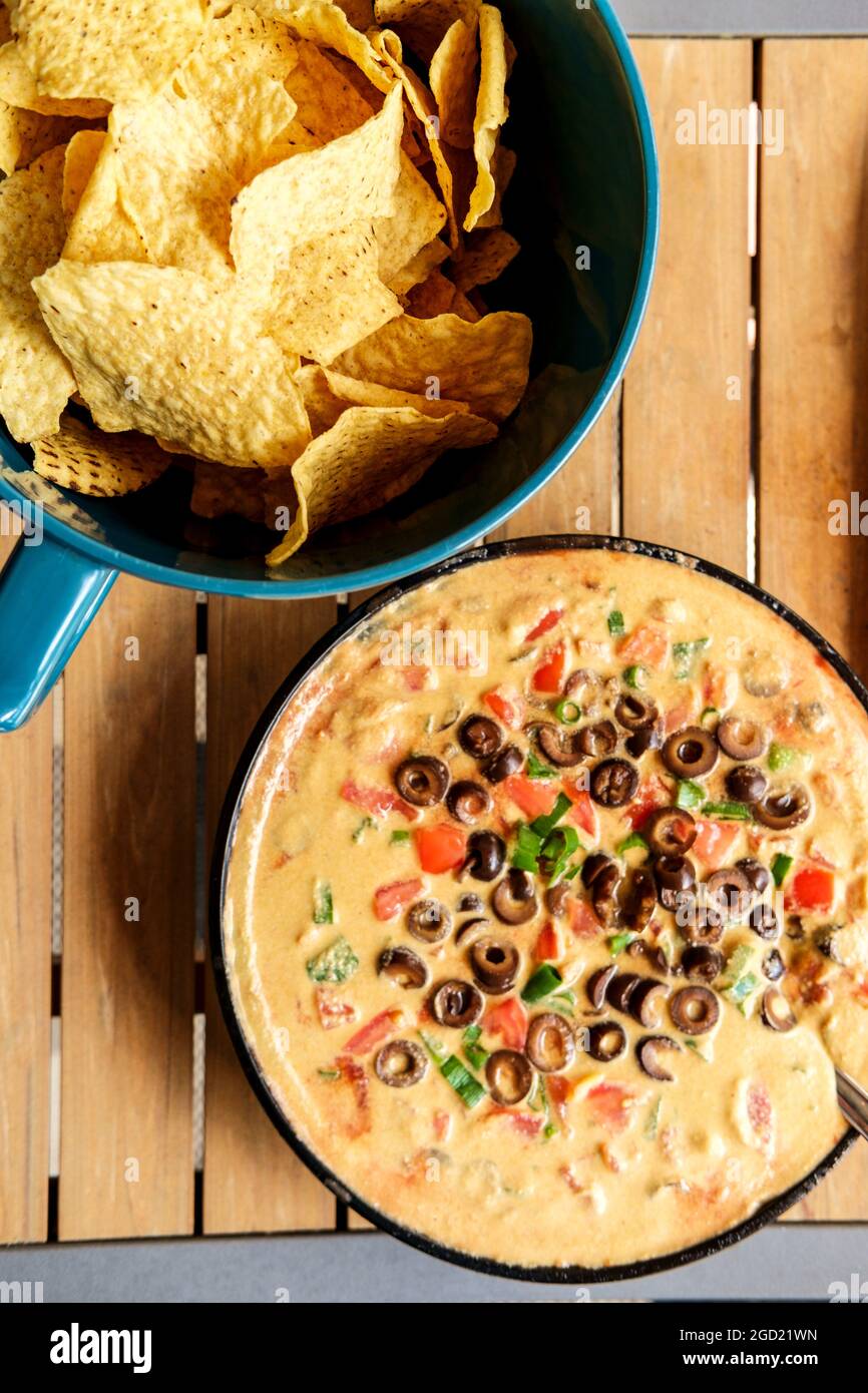 Tortilla chips with five layer queso cheese dip Stock Photo - Alamy