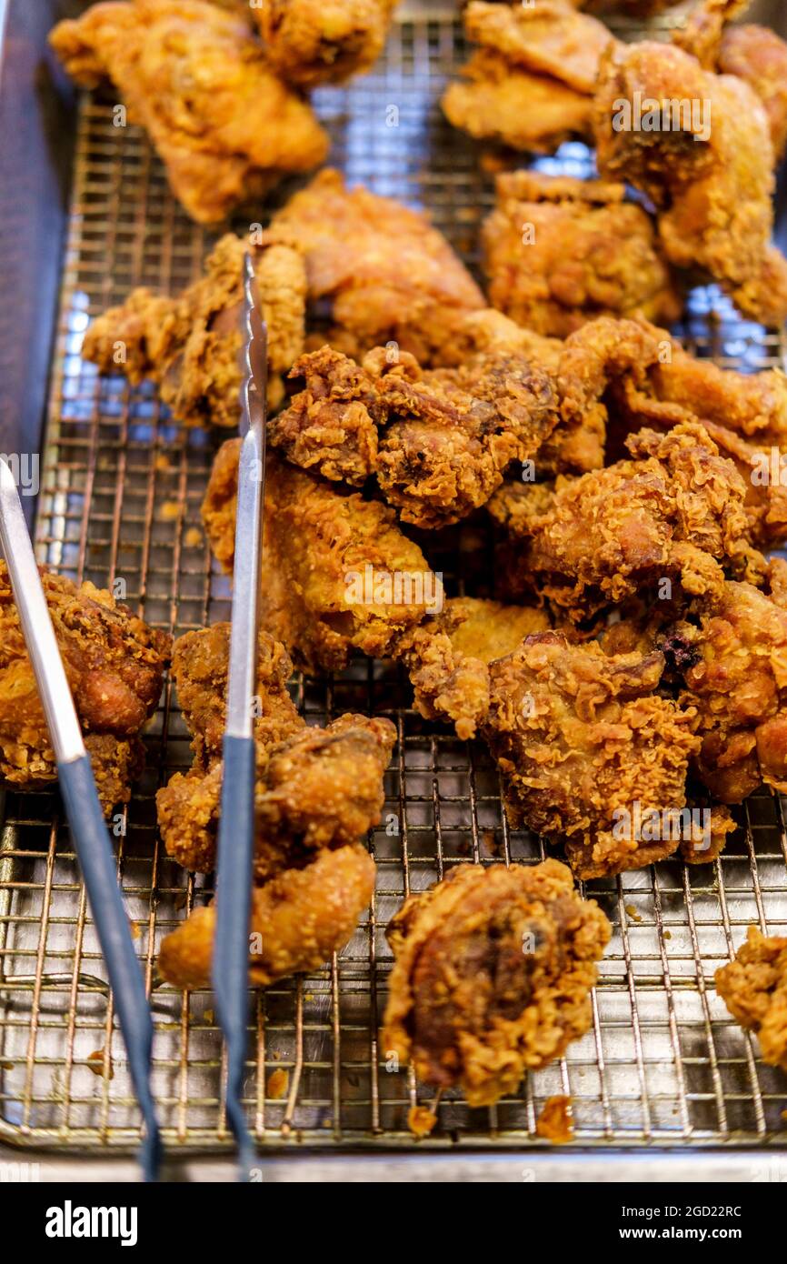 Fried chicken wings buffet station with serving tongs Stock Photo - Alamy