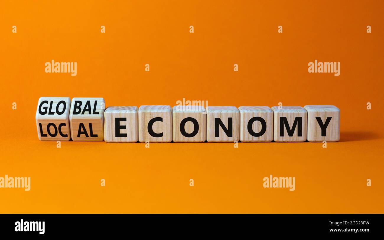 Local or global economy symbol. Turned wooden cubes and changed words ...