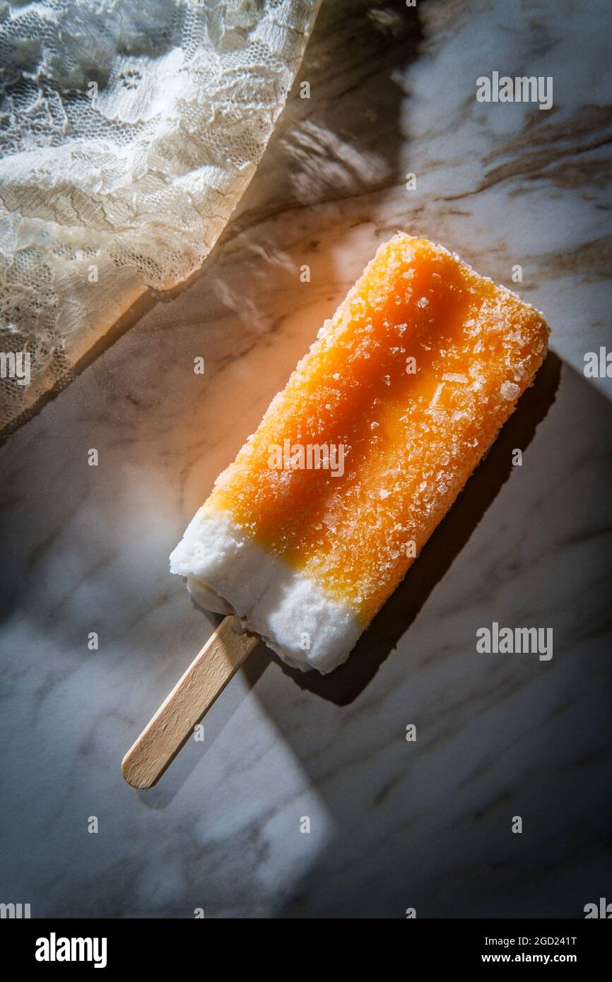 Refreshing frozen dessert Orange and cream ice pop on a stick Stock ...