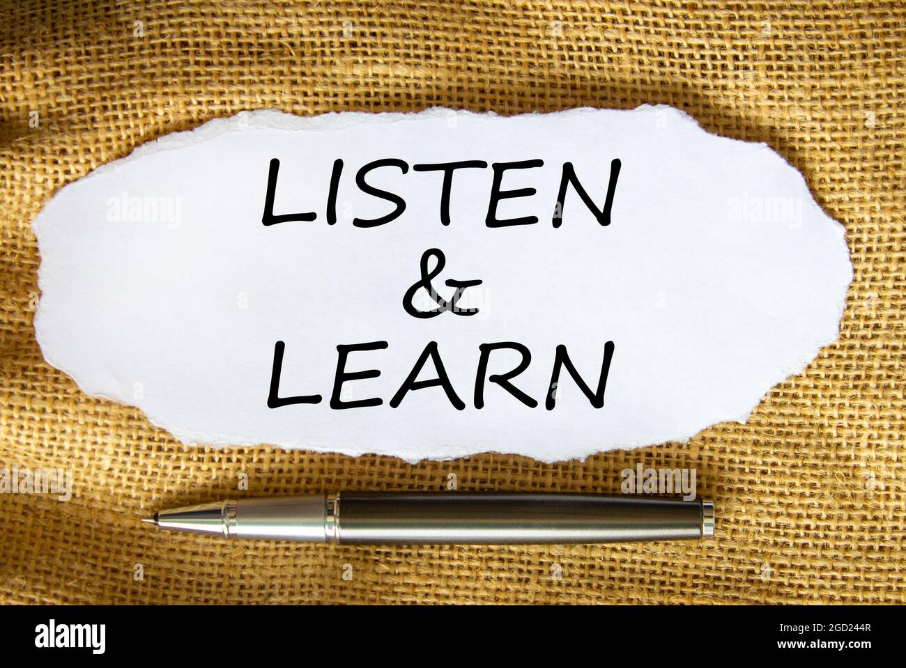 Listen and learn symbol. Words 'Listen and learn' on white paper. Black ...