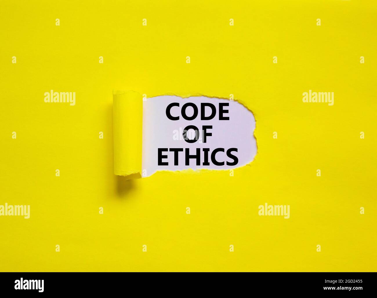 Code of ethics symbol. Words 'Code of ethics' appearing behind torn ...