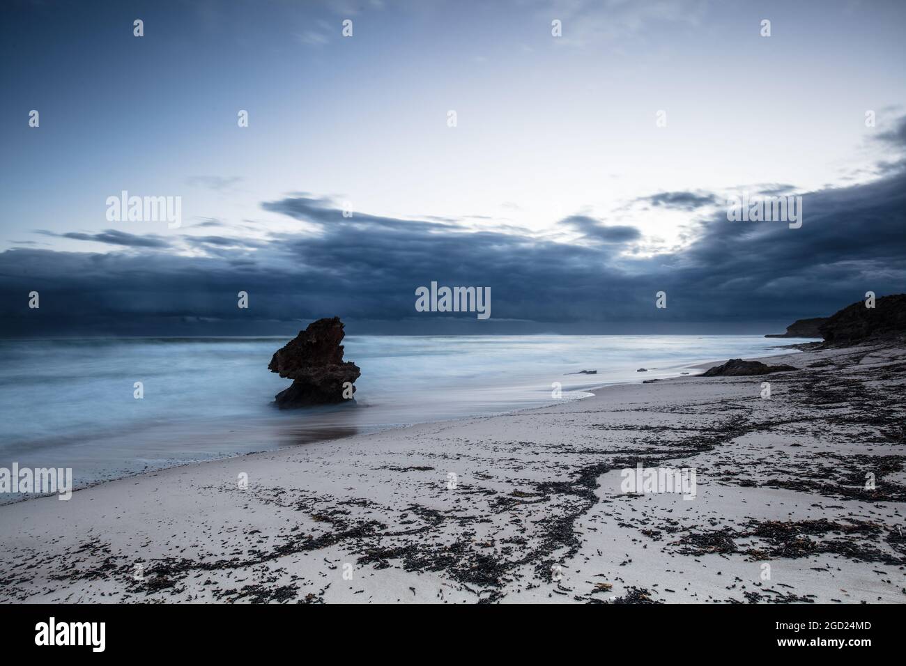 The idyllic Number Sixteen Beach with an incoming storm at dusk in Rye ...
