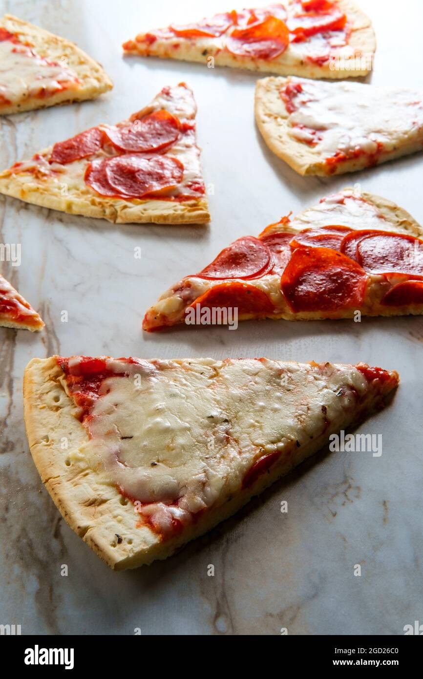 New York style pizza slices on marble kitchen table Stock Photo - Alamy