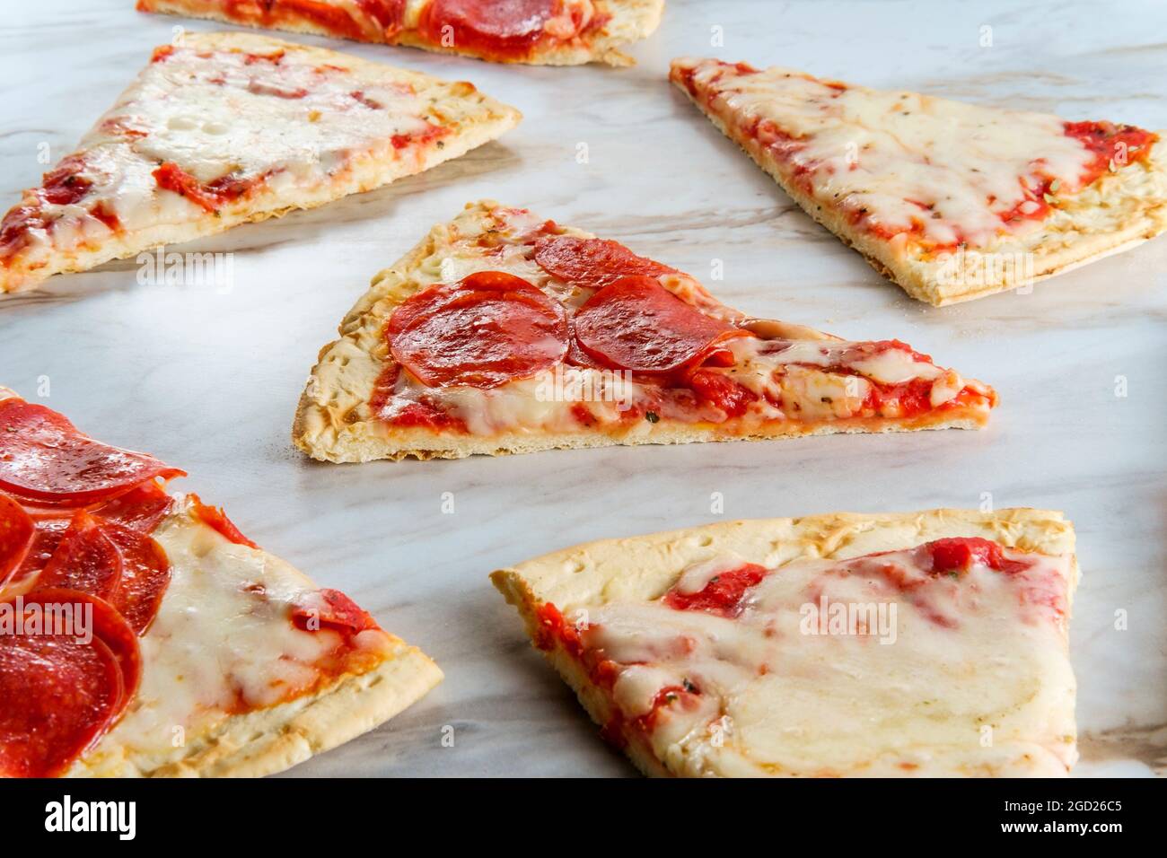 New York style pizza slices on marble kitchen table Stock Photo - Alamy