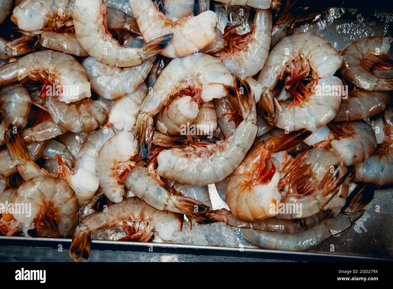 Fresh raw shell-on unpeeled shrimp chilling on ice Stock Photo - Alamy