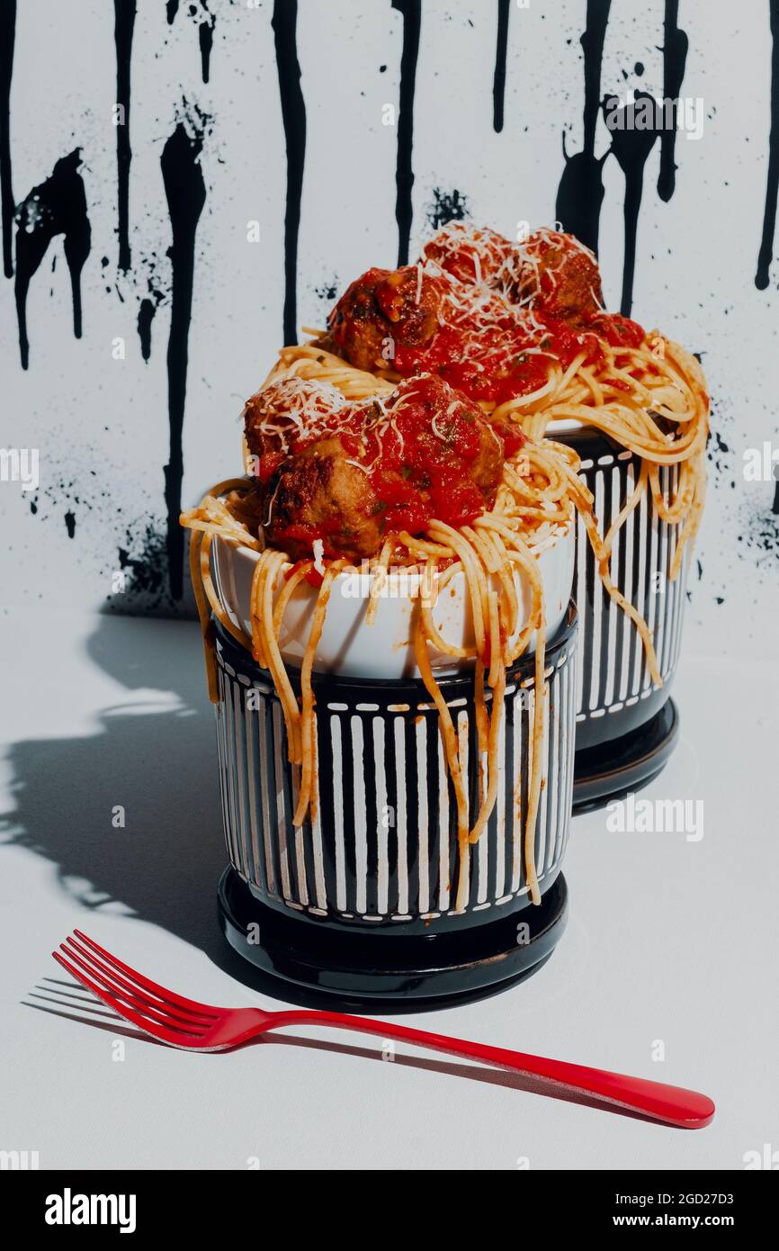 Italian spaghetti and meatballs in marinara sauce with abstract paint ...