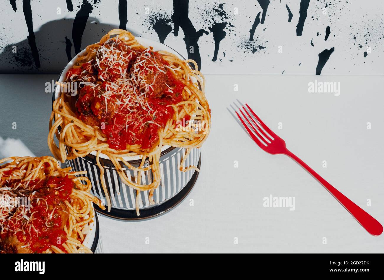 Italian spaghetti and meatballs in marinara sauce with abstract paint ...