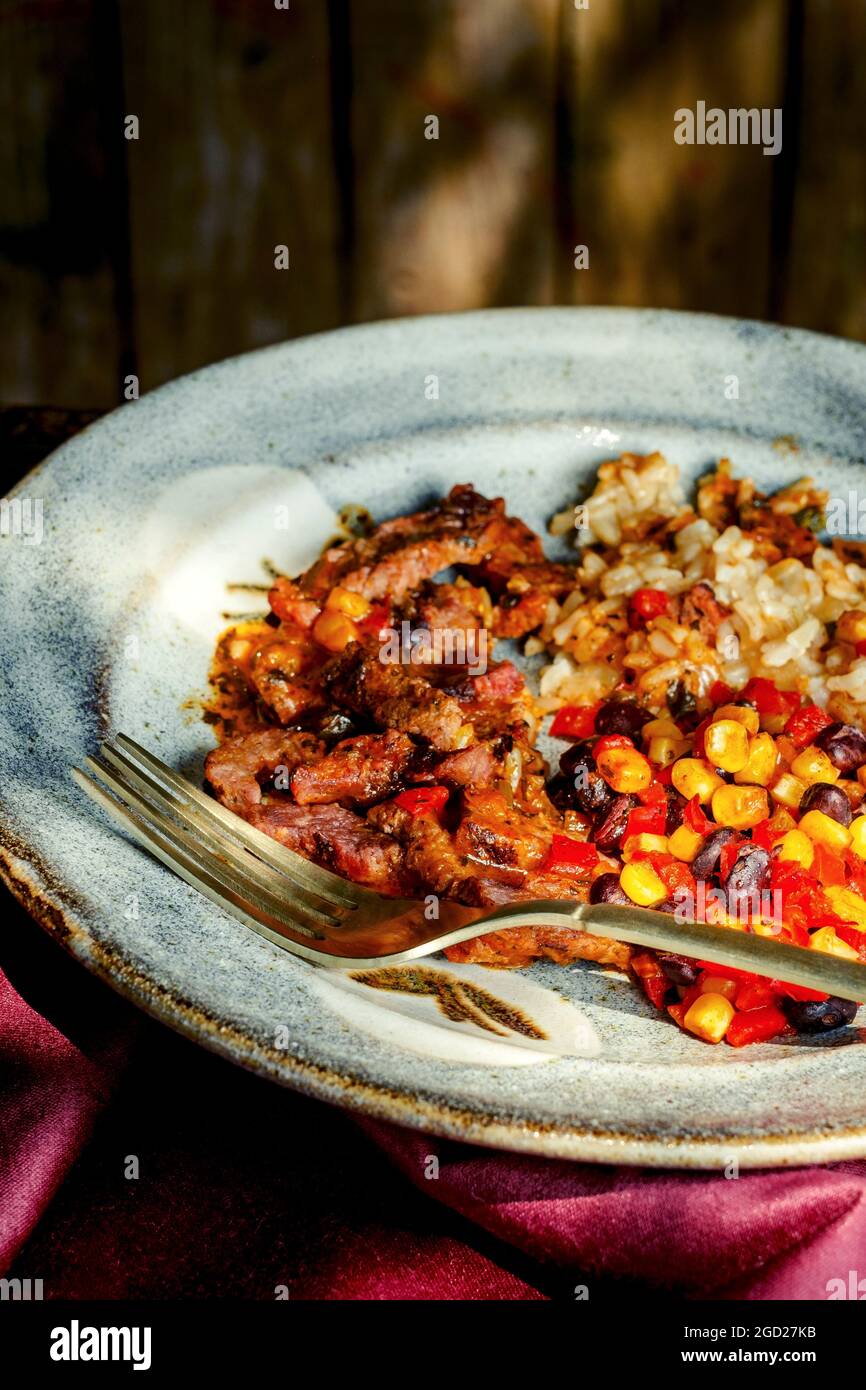 Mexican grilled steak carne asada served with brown rice and beans with ...