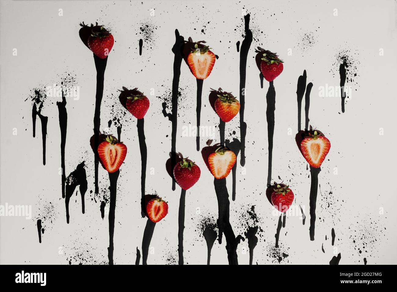Fresh strawberries on abstract black and white paint drip background ...