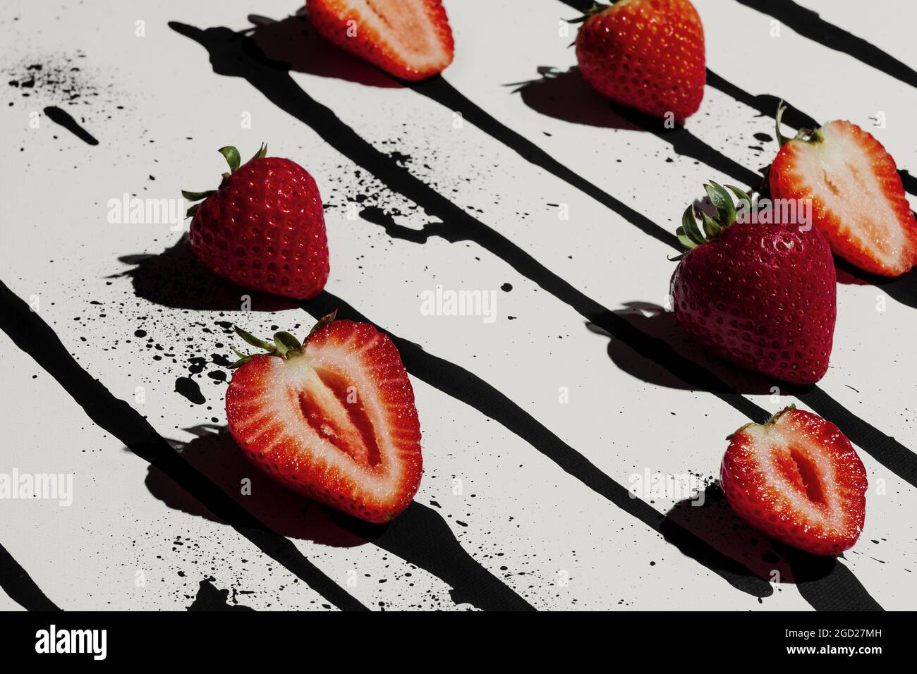 Fresh strawberries on abstract black and white paint drip background ...