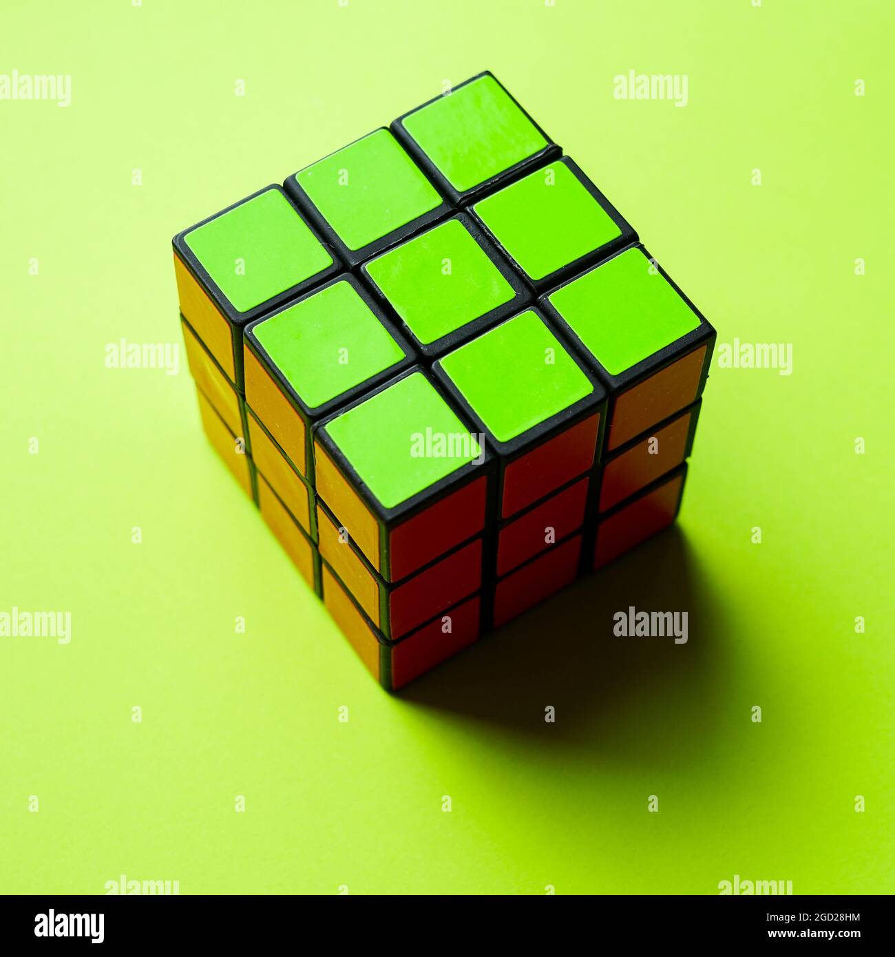 Rubik's cube green side on a table with black shadow Stock Photo - Alamy