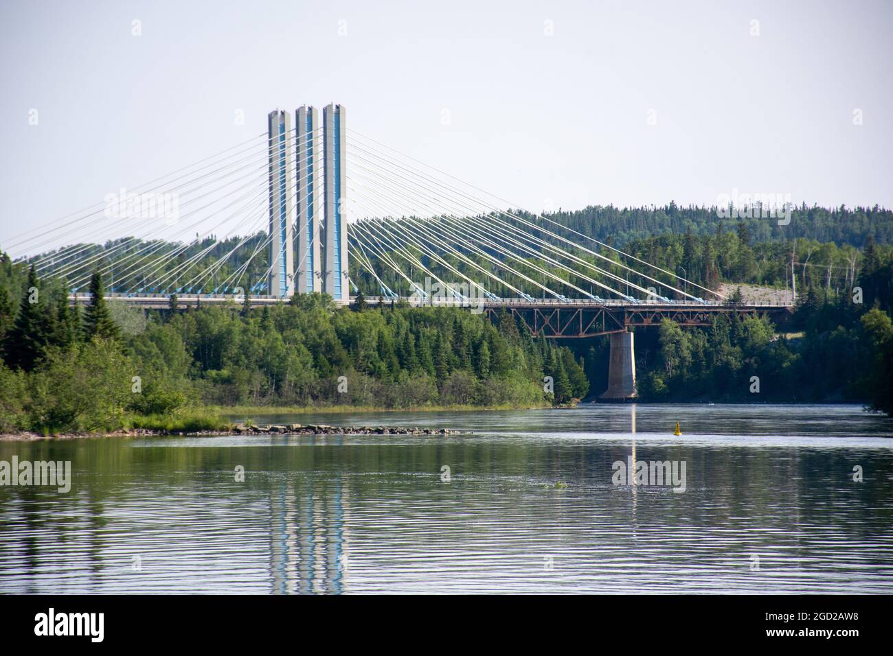 Modern bridge over the large river in a greenery Stock Photo - Alamy