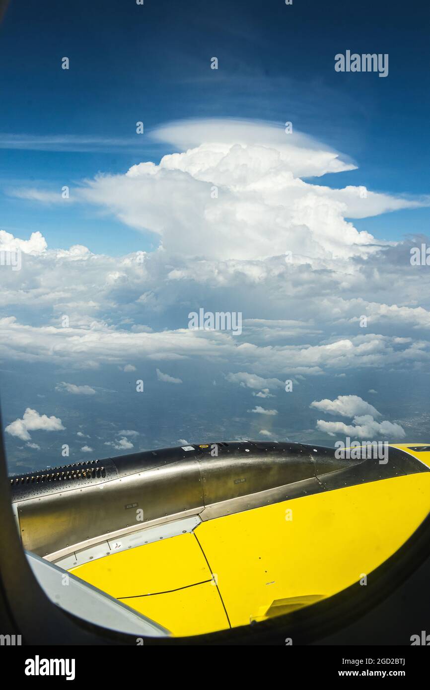 Vertical shot of a blue sky with clouds from an airplane window Stock ...