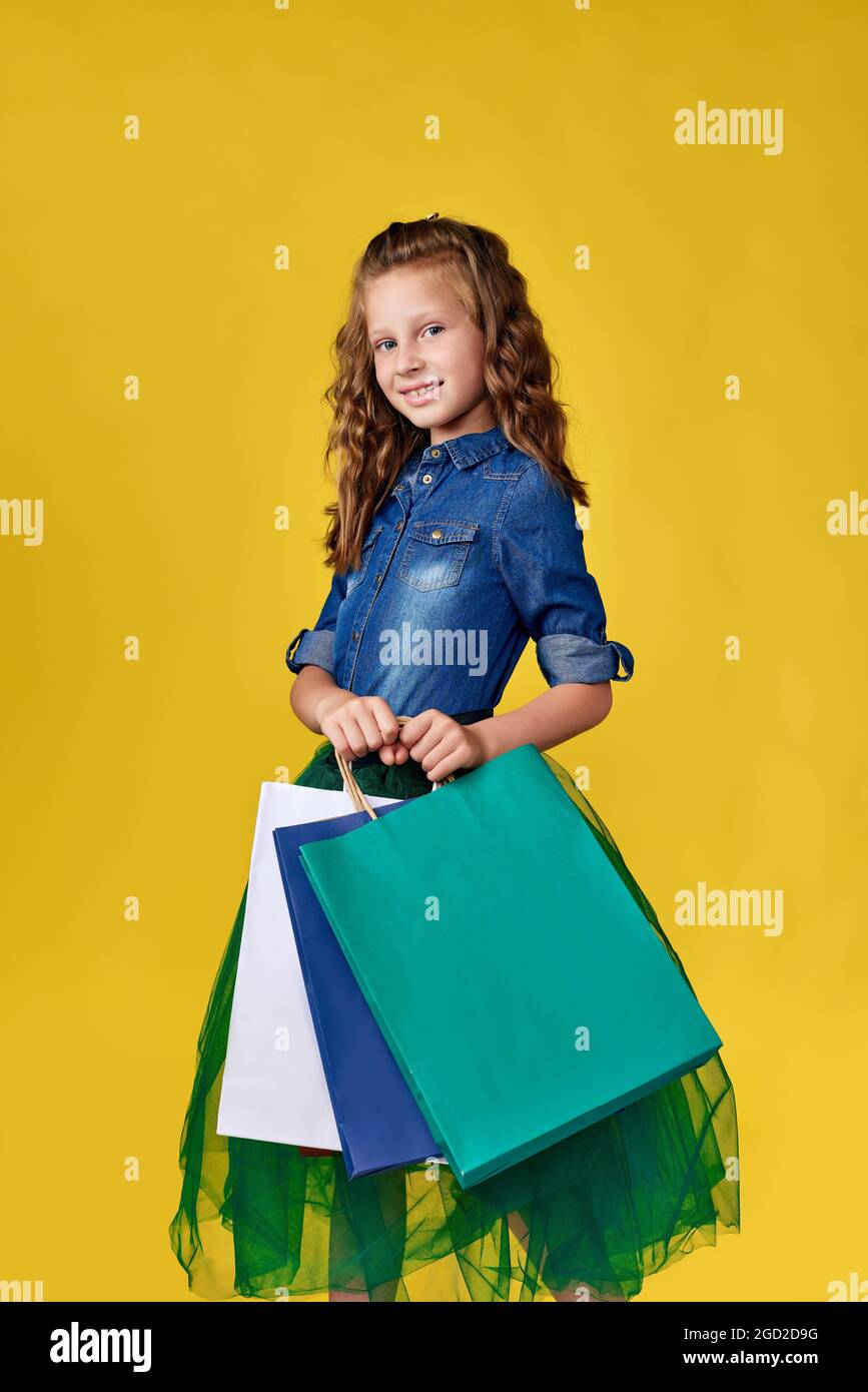 cute little caucasian redhead child girl holds shopping bags Stock ...