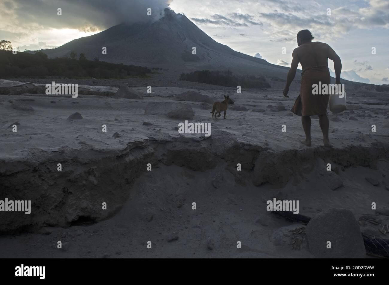 A resident, Rahmad Sitepu, 36, seen during bathing at the Borus river ...