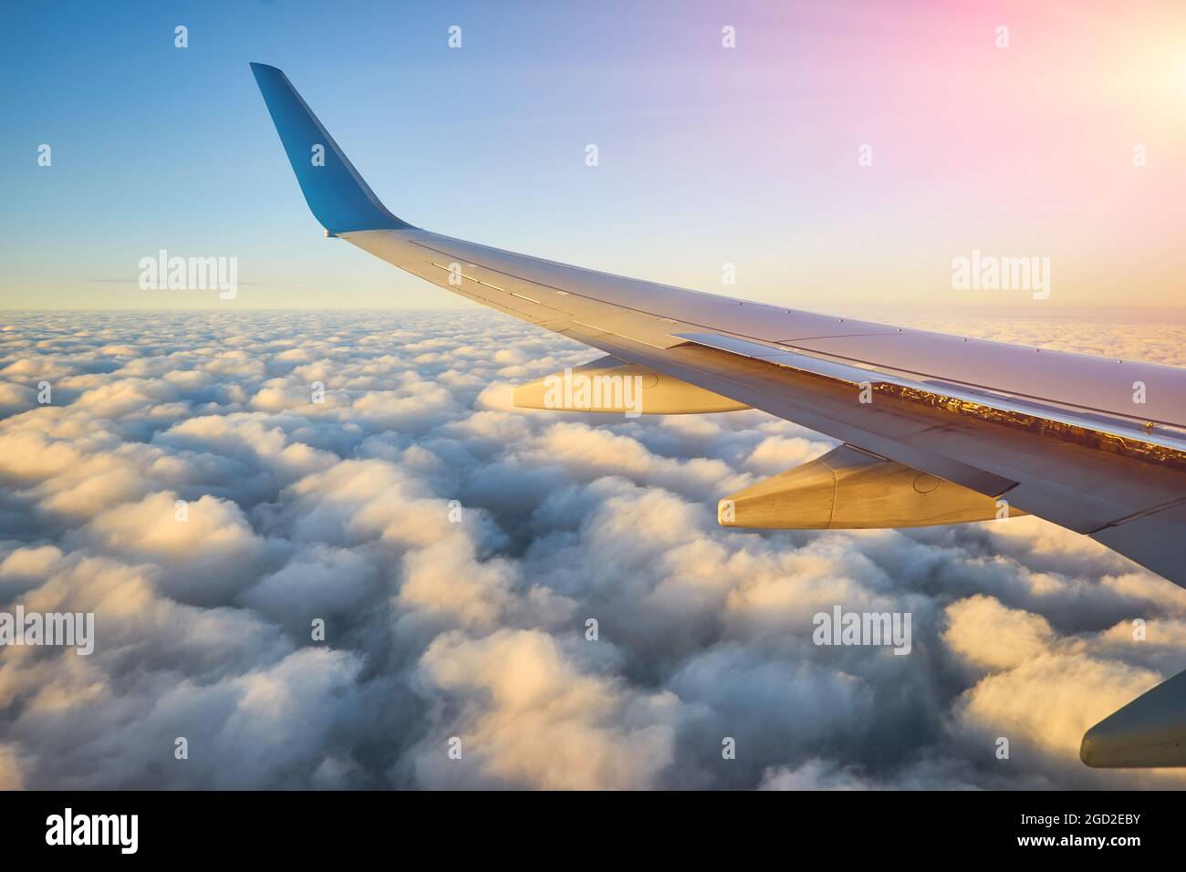 Spectacular view of a sunset above the clouds from airplane window ...