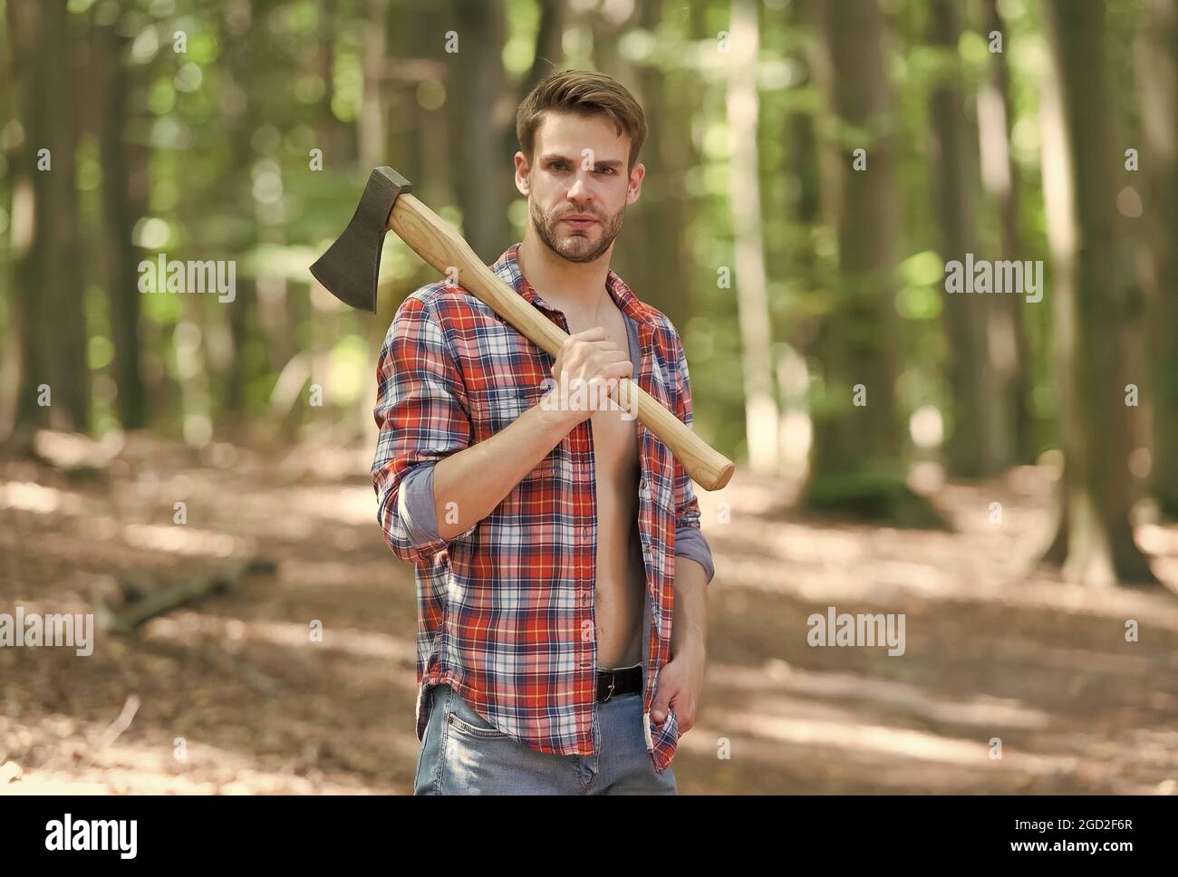 Unleashing your inner lumberjack. Handsome guy carry axe on natural ...