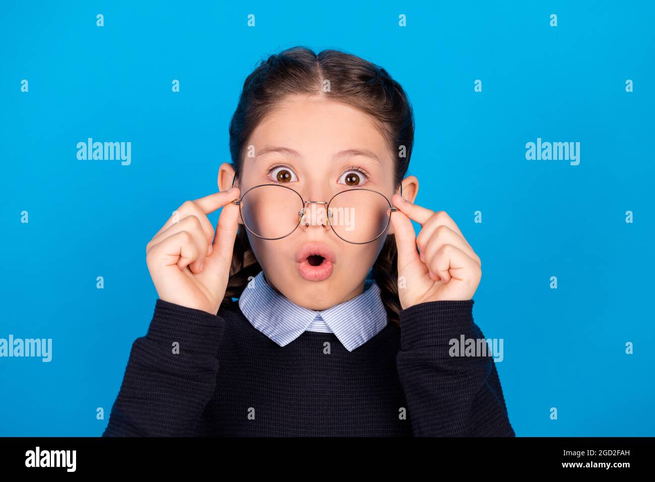 Photo of young school girl amazed shocked surprised hands touch ...