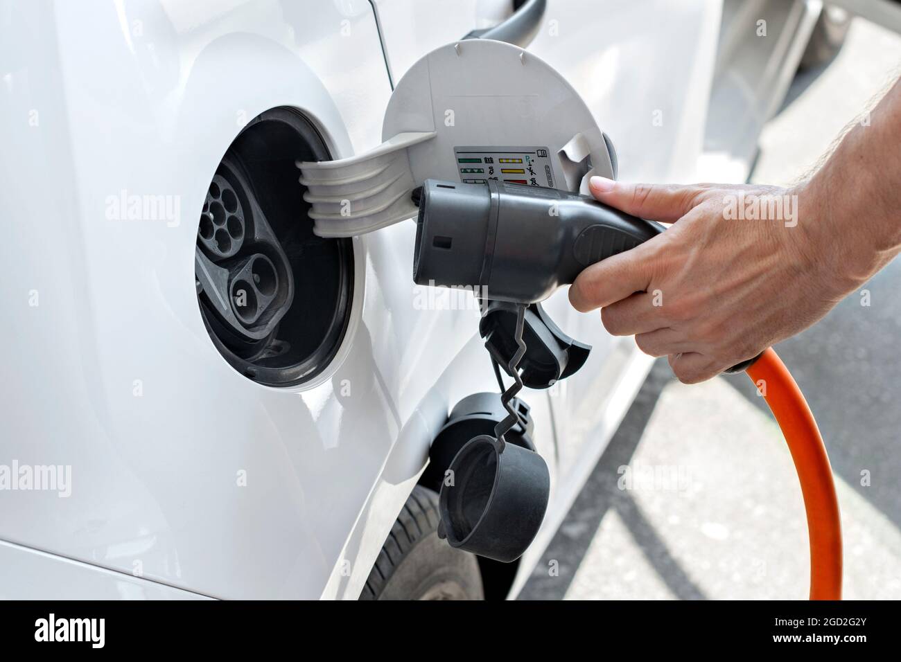 Human hand is holding electric car charging Stock Photo - Alamy