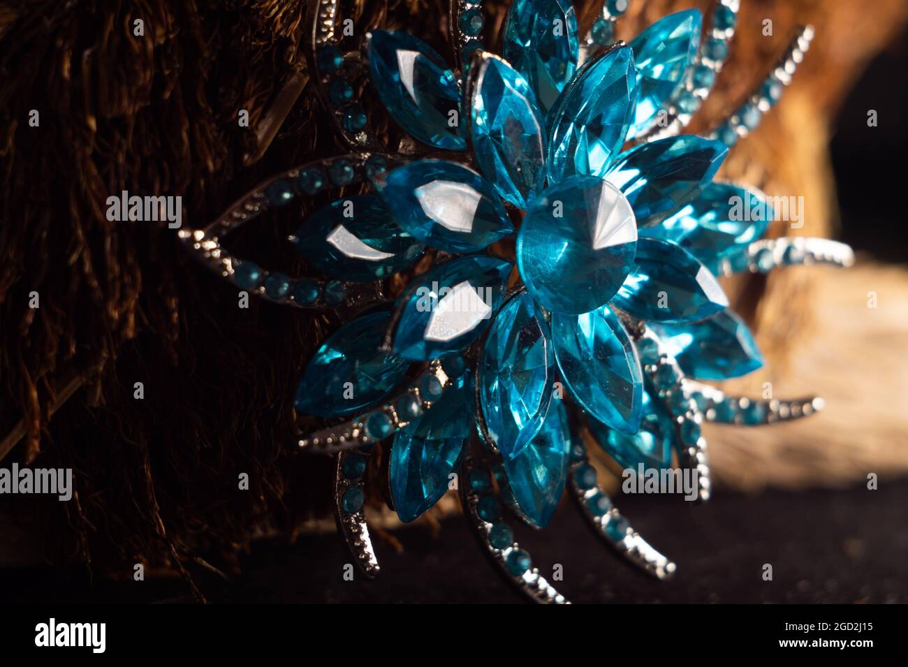 Closeup of a floral brooch embellished with blue gems and diamond ...