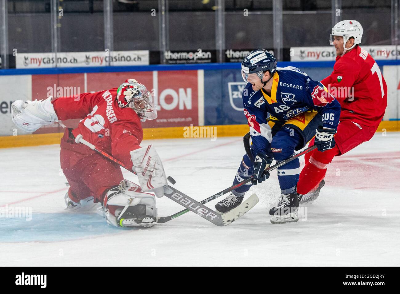 Carl Klingberg # 48 (EV Zug) is placed by # 29 goalkeeper Luca ...