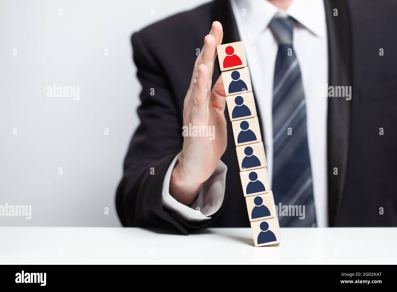 Businessman hands stopping wooden block from falling. Risk and support ...